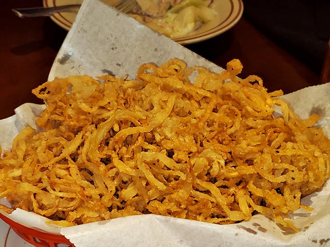 These onion straws aren't just a side dish – they're crispy, golden tangles of happiness that'll make you forget potato chips ever existed.