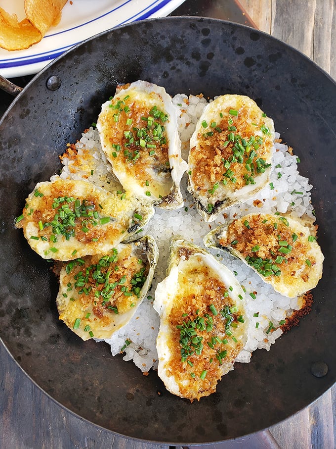 These aren't just oysters Rockefeller—they're oysters that clearly made some excellent investments. The golden-brown crust hides creamy decadence beneath.