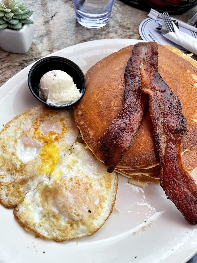 The pancake-egg-bacon trinity that proves sometimes the classics don't need reinvention—just perfect execution and a side of butter.