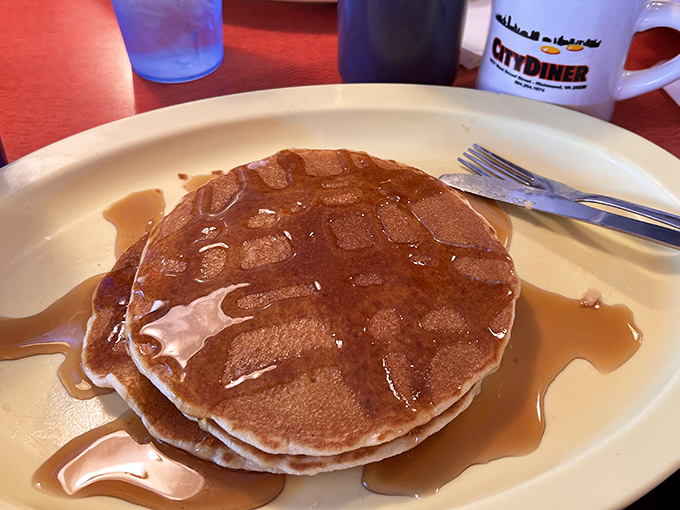 These pancakes aren't just breakfast, they're an engineering marvel—perfectly golden discs swimming in maple syrup that would make Vermont jealous.
