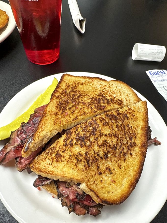 The pastrami melt that launched a thousand food pilgrimages. That golden-brown grilled bread is just the beginning of the journey.
