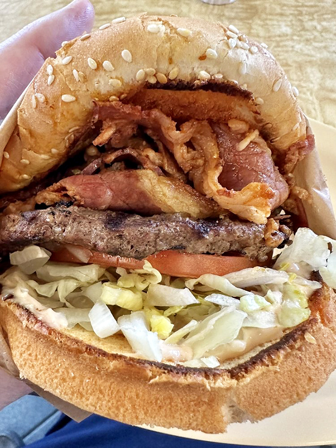 This isn't just a burger—it's architecture. Layers of pastrami, beef, and fresh veggies create a skyscraper of flavor that demands a strategic first bite.
