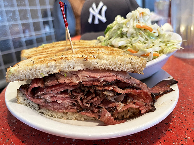 Pastrami piled so high it defies gravity, served on rye bread that knows its important purpose.