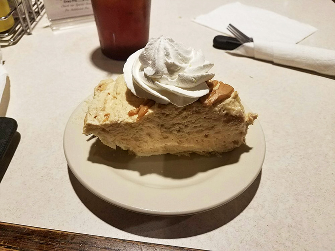 Peanut butter pie with a cloud of whipped cream—proof that sometimes the simplest desserts create the most profound moments of silence at the table.