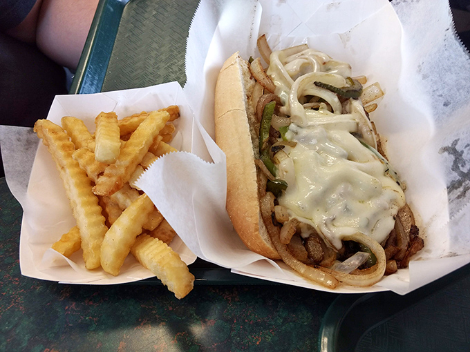 Behold the Philly cheesesteak in its natural habitat—tender meat, melted cheese, and grilled onions nestled in a perfect roll. Philadelphia might need to annex Columbia.