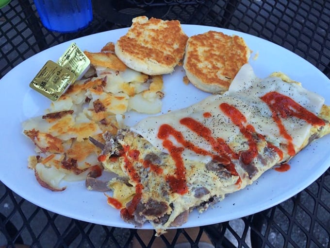 The Philly Omelet doesn't just nod to Philadelphia—it gives it a full Florida bear hug with melted cheese cascading over eggs like a yellow waterfall of joy.
