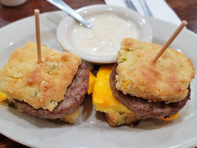 Breakfast sandwiches that require engineering degrees to eat. Layers of sausage, egg, and cheese nestled between golden biscuits—morning architecture at its finest.