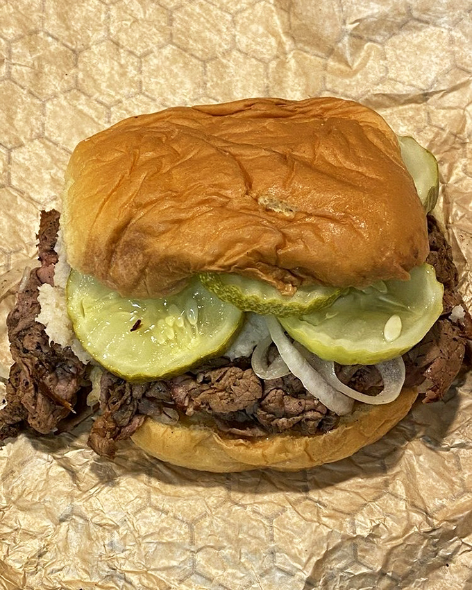The classic pit beef sandwich in all its glory – thinly sliced, perfectly pink meat piled high on a kaiser roll with raw onions and pickles. Baltimore's answer to the cheesesteak.