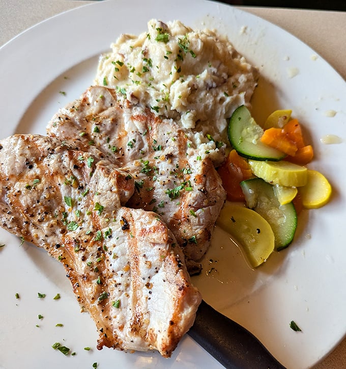 These pork chops don't need a social media manager – they sell themselves with juicy perfection and classic sides that haven't changed because they've never needed to.