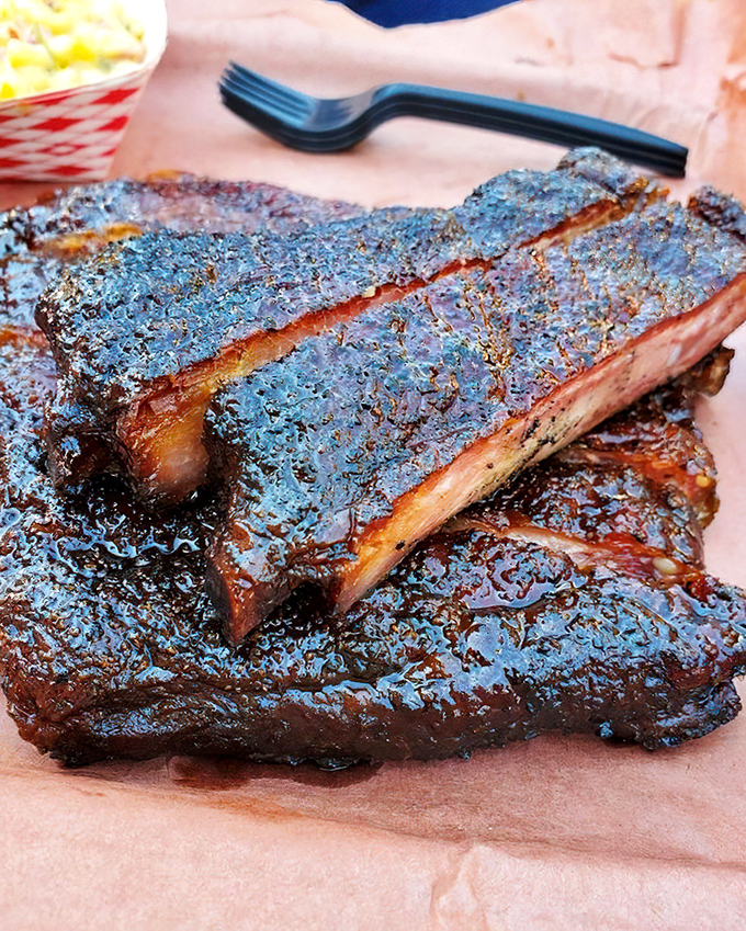 These ribs have the kind of bark that makes tree trunks jealous. The glistening exterior promises a flavor explosion worthy of fireworks.
