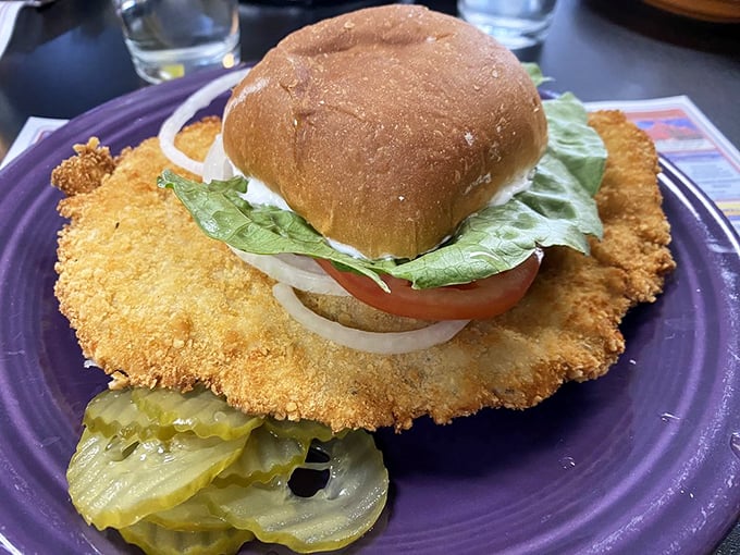 The famous tenderloin sandwich that requires its own zip code – a golden-fried masterpiece that makes the bun look like it's playing a supporting role.