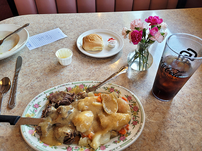 The legendary pot roast arrives on a floral-patterned plate—like eating at grandma's house, if grandma was a culinary genius.