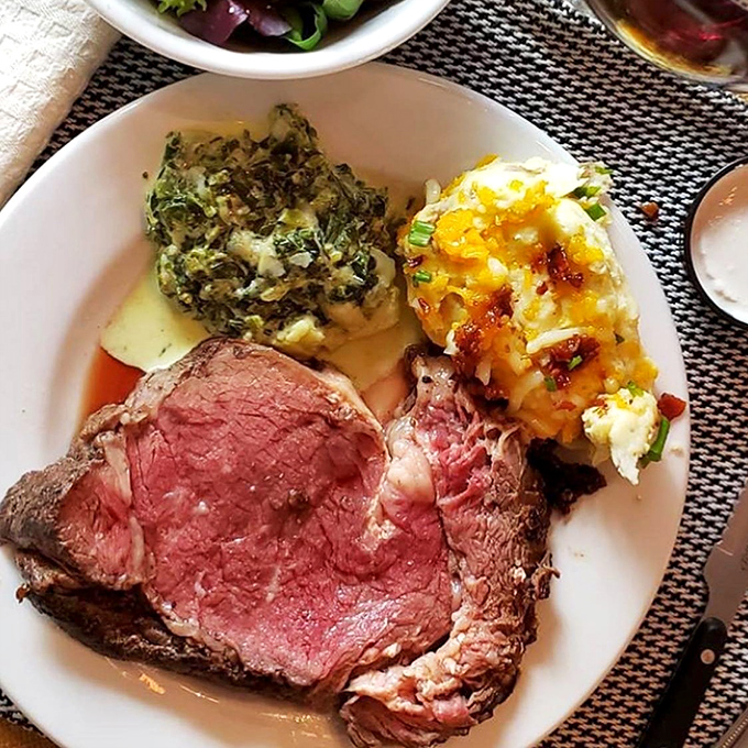 This prime rib isn't just cooked—it's been lovingly persuaded to perfection, flanked by sides that refuse to be mere supporting characters.