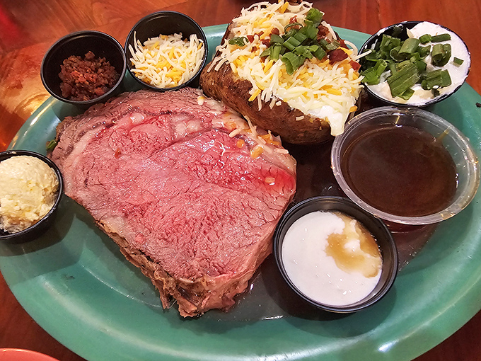 Not all treasures come from the sea. This prime rib arrives perfectly pink with a loaded baked potato—proof that landlubbers eat royally here too.