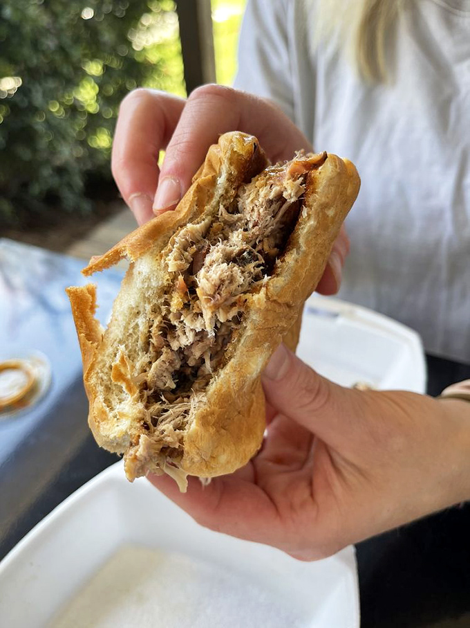 This pulled pork sandwich isn't just a meal—it's edible architecture, with tender strands of smoky pork practically begging to be devoured.