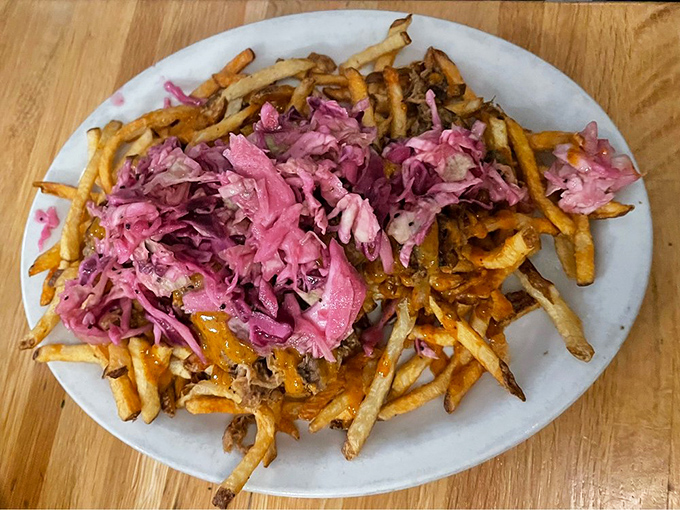 These aren't your average fries – they're a canvas for pulled pork and vibrant slaw, creating a handheld flavor festival that demands to be shared.
