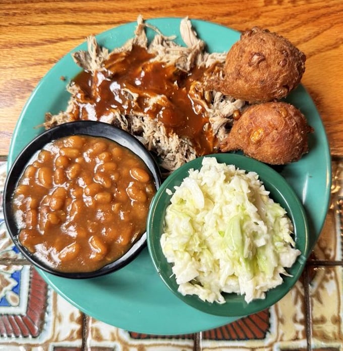 Southern hospitality on a plate—pulled pork, baked beans, and coleslaw form the holy trinity of comfort food done right.
