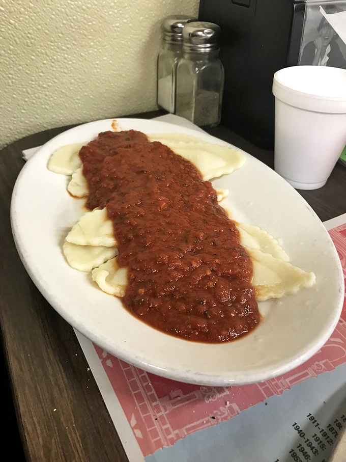 Ravioli swimming in a sea of homestyle meat sauce. These pillows of pasta aren't just comfort food—they're therapy on a plate.