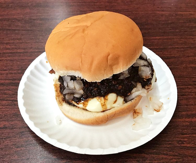 Behold the classic burger in its natural habitat – simple, honest, and ready to remind you why sometimes the basics are all you need.