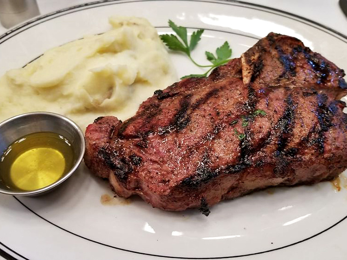 Behold the ribeye in its natural habitat—perfectly charred exterior, blushing interior, and a side of potatoes that aren't trying to reinvent the wheel, just perfect it.