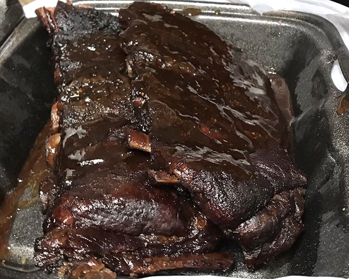 These ribs have that mahogany sheen that BBQ dreams are made of. The kind of bark that makes you want to compose poetry or at least make inappropriate noises while eating.
