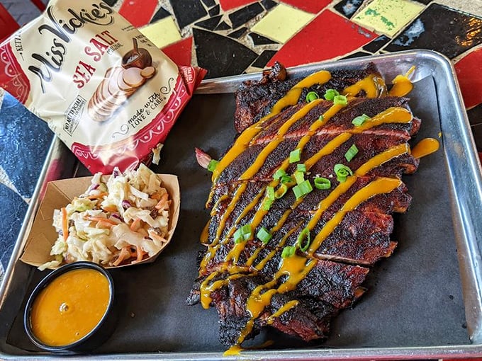 Ribs so perfectly charred and sauced they deserve their own Instagram account. That yellow drizzle isn't just decoration—it's flavor architecture.