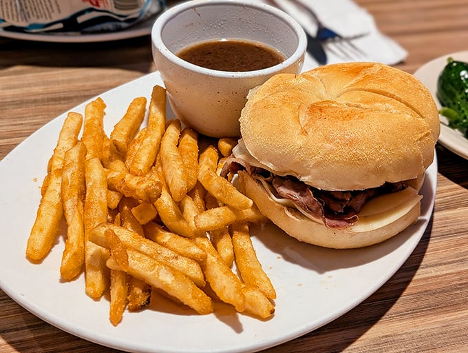 The French dip's sophisticated cousin – roast beef so tender it practically surrenders, paired with a side of jus that deserves its own fan club.