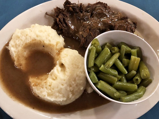 Fork-tender roast beef swimming in rich gravy alongside mashed potatoes and green beans—the holy trinity of Midwestern Sunday dinners.