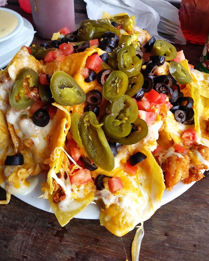 Seafood nachos that would make a Tex-Mex purist weep with joy – crispy chips buried under an avalanche of Gulf treasures.
