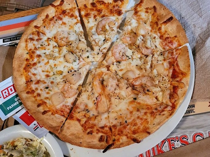 The seafood pizza—where Italian tradition meets Gulf Coast abundance. Those plump shrimp aren't just toppings; they're the main event.
