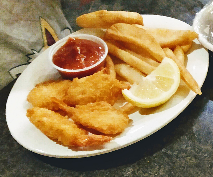 Golden-fried shrimp that snap with each bite, paired with crispy fries and tangy cocktail sauce—seafood simplicity that never goes out of style.