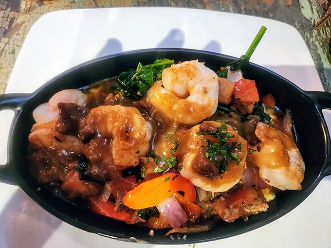 Shrimp and grits elevated to an art form—plump crustaceans swimming in savory goodness atop a bed of creamy Southern comfort.