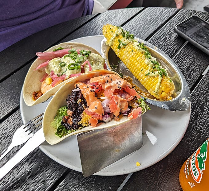 Taco Tuesday meets barbecue brilliance with these flavor-packed handheld treasures. That corn on the side isn't playing a supporting role—it's stealing scenes.