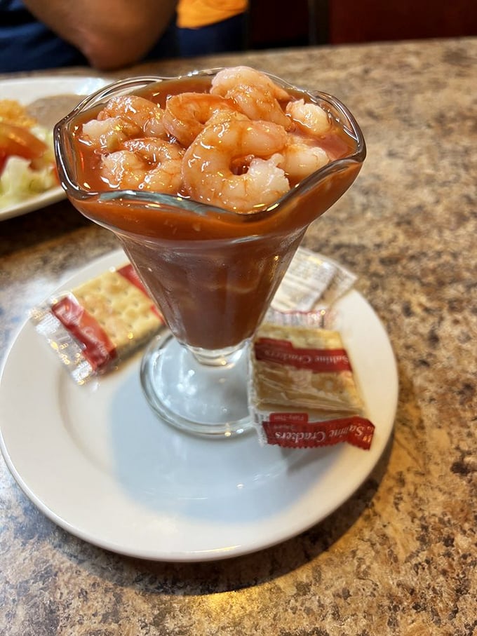The legendary shrimp cocktail—plump crustaceans swimming in a tomato elixir so good you'll be tempted to drink what's left when no one's looking.