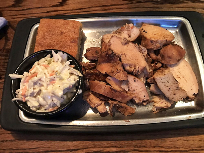 Smoked chicken that actually stays moist is the unicorn of barbecue. This plate, with cornbread and slaw, is proof miracles exist.