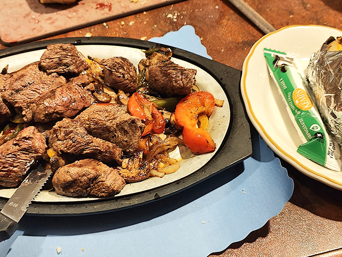 Steak that speaks for itself—no fancy plating required when the meat is this good, served sizzling hot with perfectly caramelized vegetables.