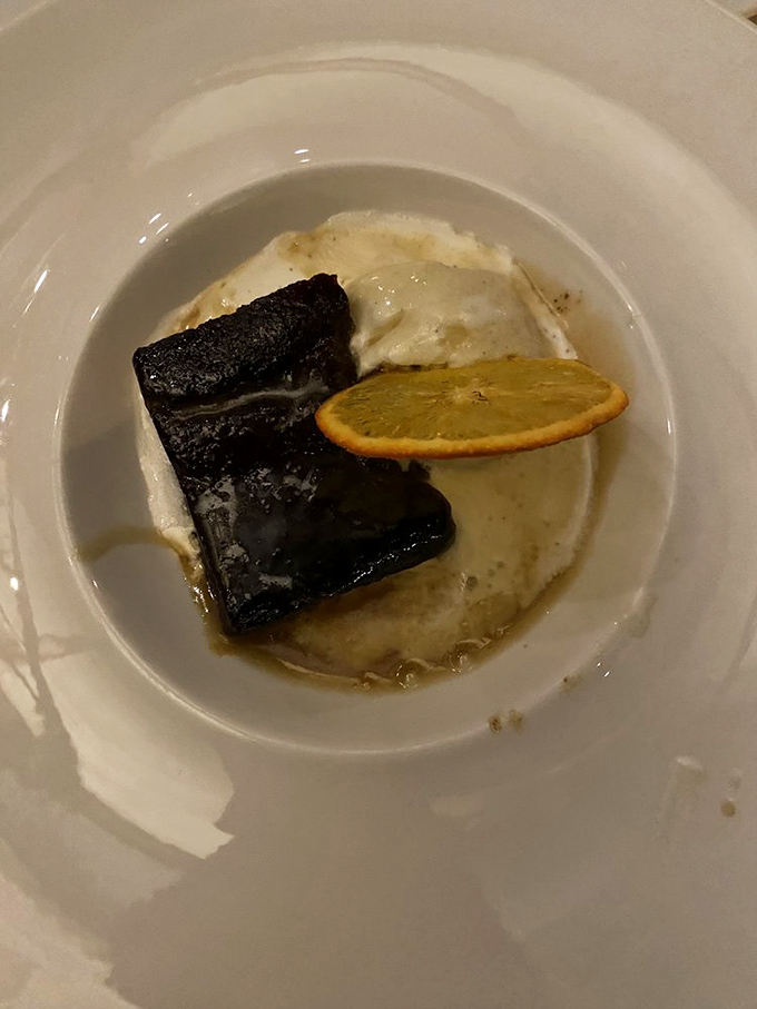 This isn't just dessert, it's therapy – rich, dark sticky toffee pudding with a bright citrus note that somehow makes indulgence feel justified.