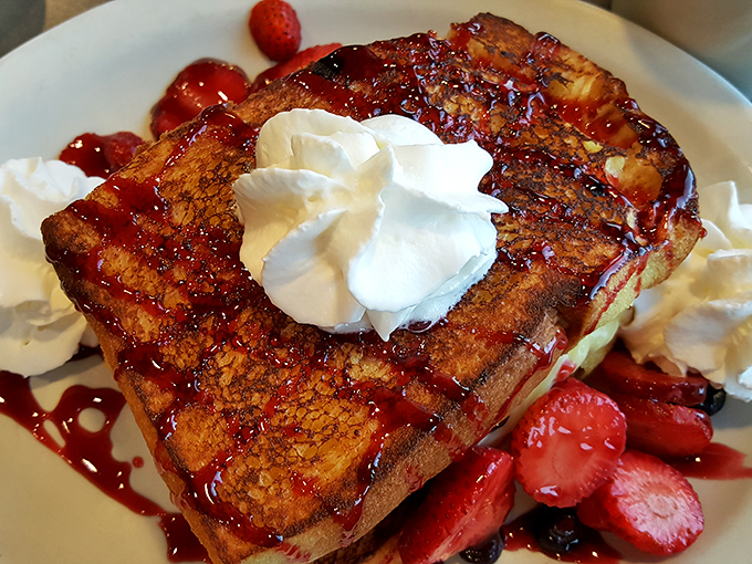 This isn't just French toast—it's a breakfast masterpiece. Thick-cut bread transformed into a berry-topped, whipped cream-crowned morning indulgence that would make Paris jealous.