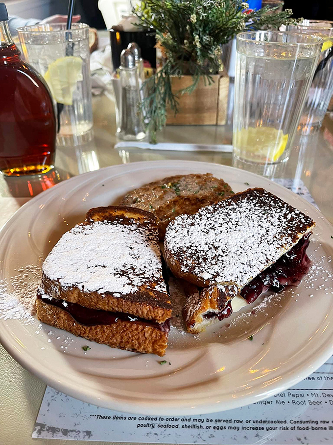 This isn't just French toast – it's French toast that went to Paris, fell in love, and came back transformed. The powdered sugar snowfall is just showing off.