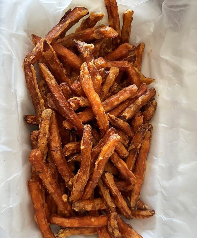 These sweet potato fries aren't just a side dish – they're crispy, golden vehicles for delivering Cajun seasoning directly to your soul.