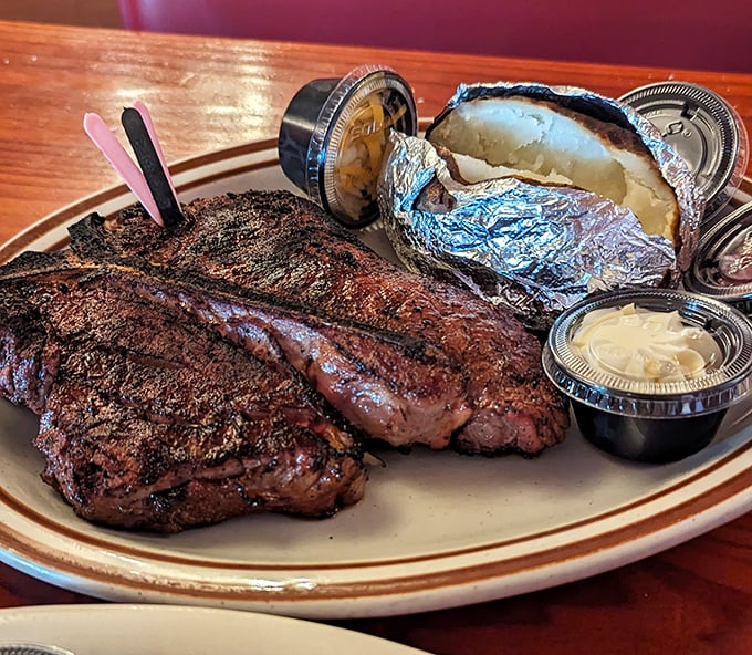 The T-bone doesn't just cross the line between strip and tenderloin—it obliterates it with flame-kissed perfection that would make cavemen proud.