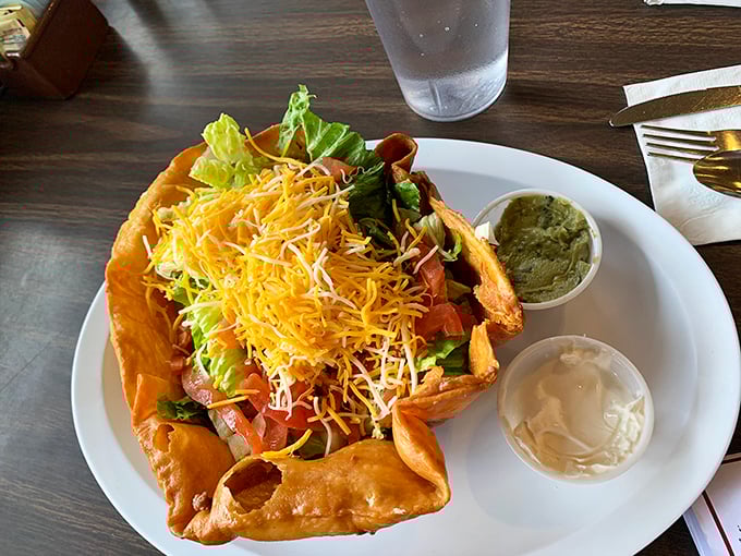 This taco salad doesn't just break out of its shell—it shatters expectations with fresh ingredients and two perfect sidekicks of sour cream and guacamole.
