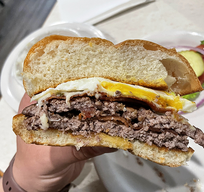 This burger doesn't need fancy aioli or brioche to impress – just honest beef, a perfectly cooked egg, and engineering that holds together until the last bite.