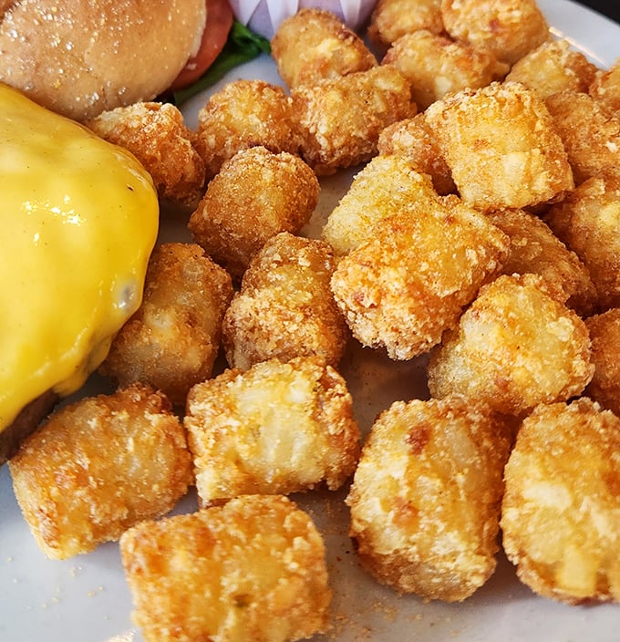 These golden-brown tater tots aren't just a side dish—they're little nuggets of potato perfection that might just steal the spotlight from your main course.