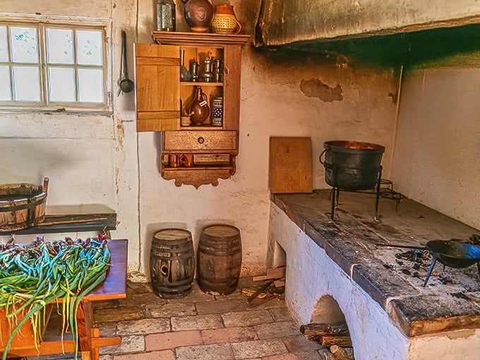 The original open kitchen concept. This traditional hearth served as both cooking area and social center—the 18th-century equivalent of gathering around the kitchen island.
