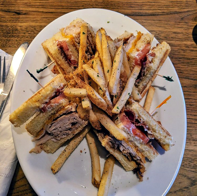The club sandwich – architecture you can eat! Layers of turkey, bacon, and veggies stacked so perfectly you almost feel bad dismantling it. Almost.