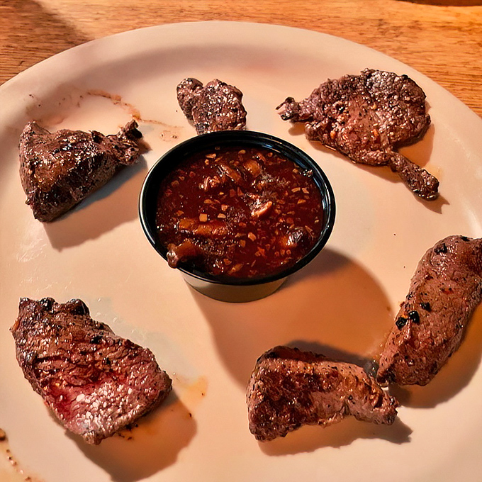 Venison medallions arranged like a carnivore's clock, with game sauce at high noon. Wild Florida never tasted so civilized.