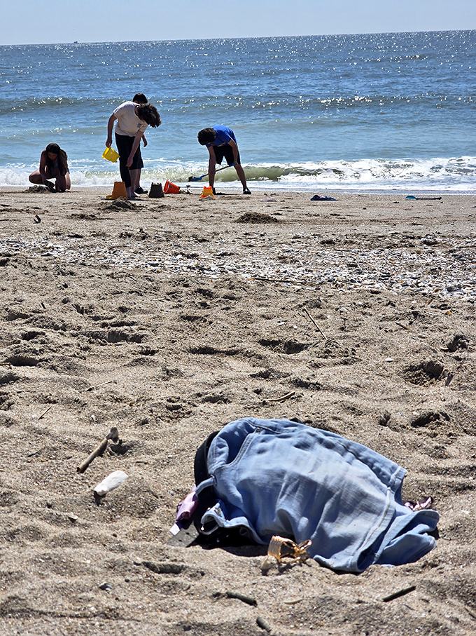 The universal language of sandcastle construction—where engineering degrees are unnecessary and ocean-front real estate is finally affordable for everyone