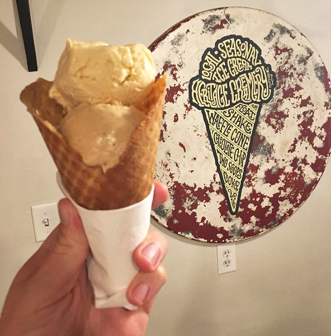 Golden waffle cone meets velvety ice cream against a backdrop of the shop's artisanal philosophy—proof that perfection comes in simple packages.