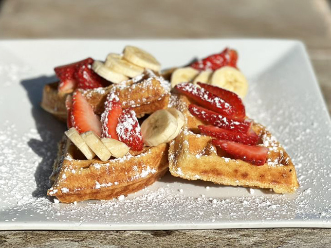 These waffles don't just carry fruit—they showcase it. Strawberries, bananas and a dusting of powdered sugar create breakfast's answer to fine art.
